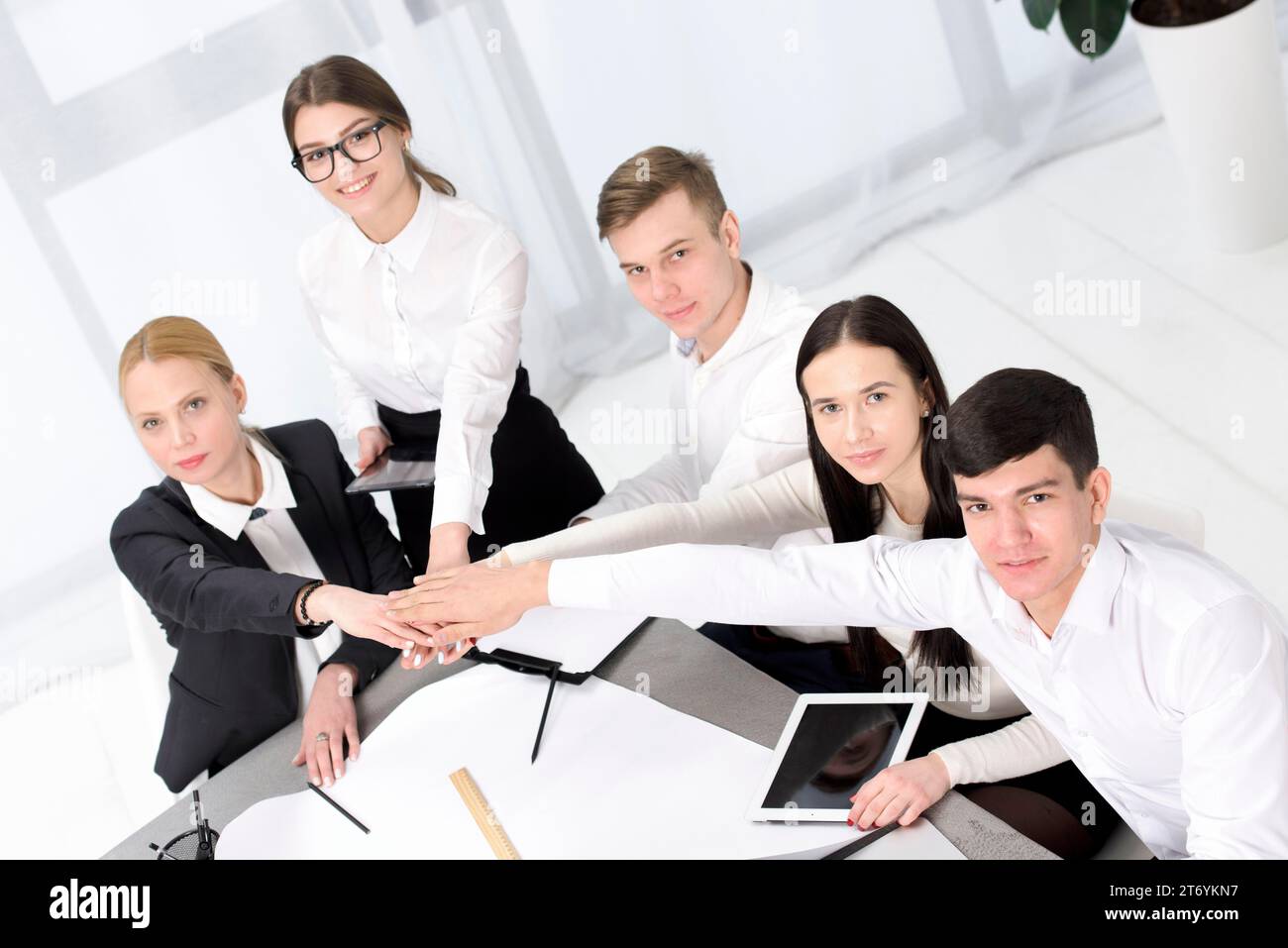 Group business people stacking each other s hand desk Stock Photo - Alamy