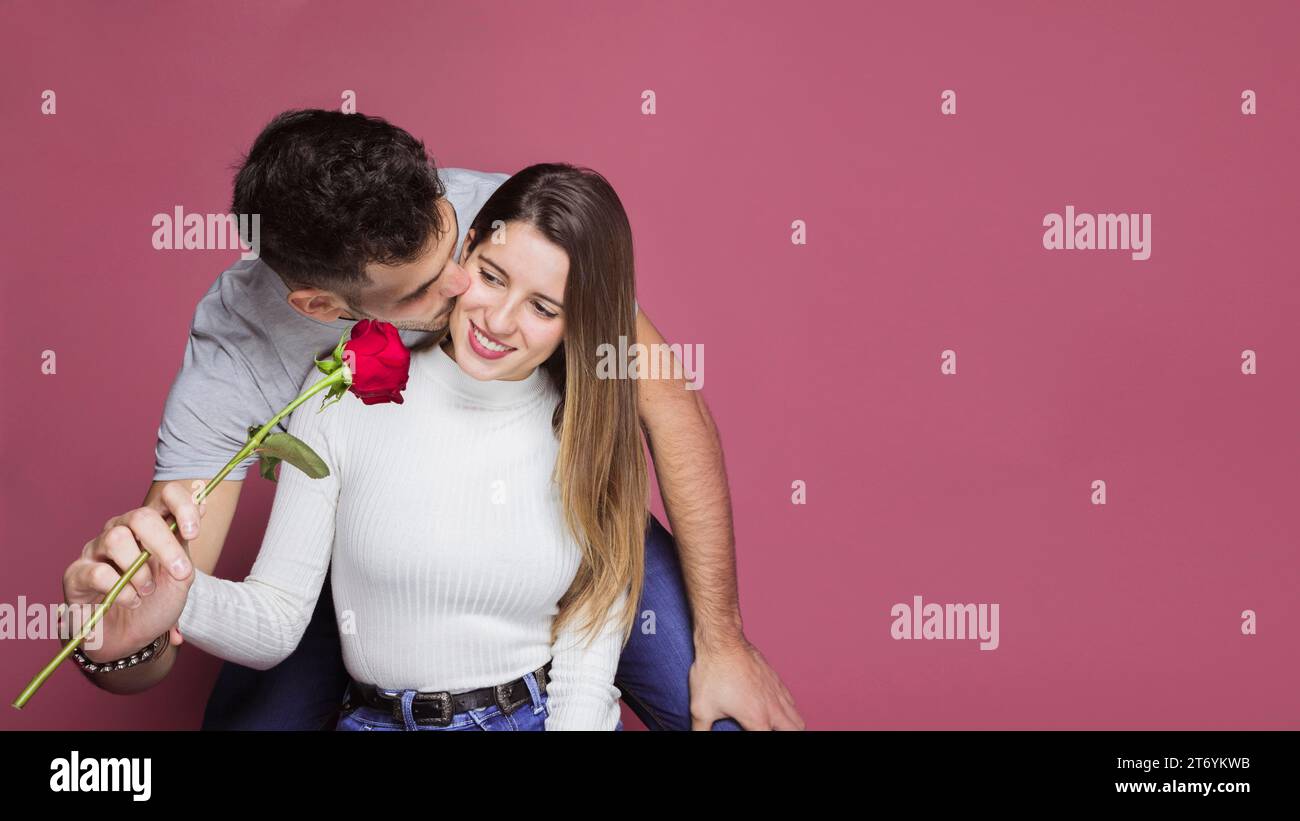 Guy kissing presenting fresh rose attractive cheerful lady Stock Photo ...