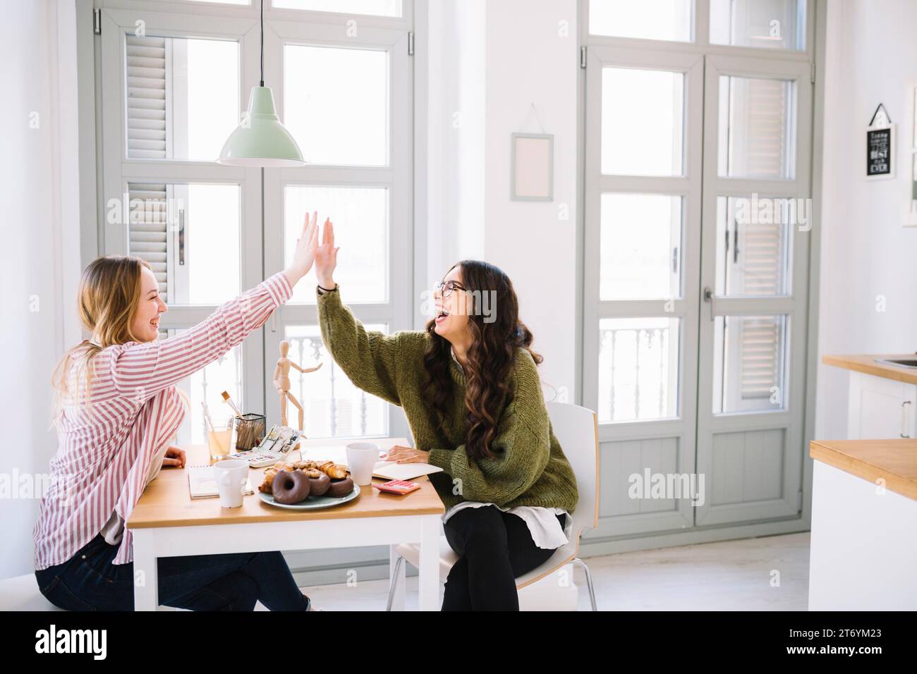 Women laughing high fiving hi-res stock photography and images - Alamy