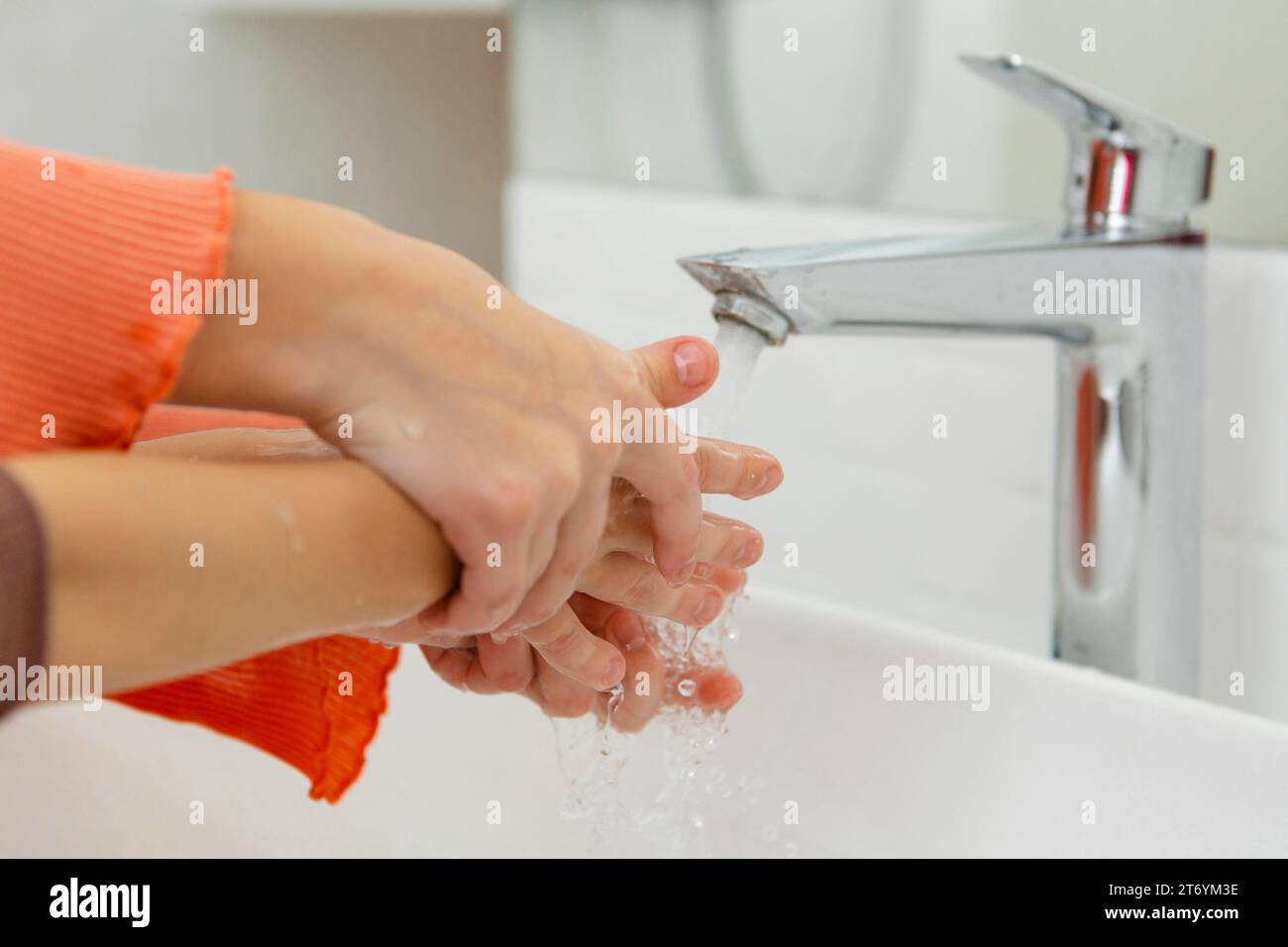 Little kids washing their hands close up Stock Photo - Alamy