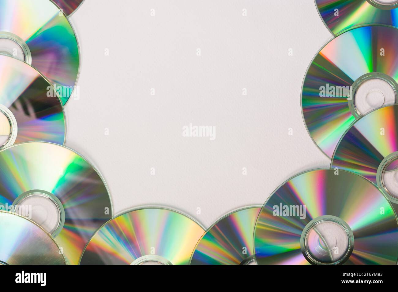 Many compact discs with space text white background Stock Photo - Alamy