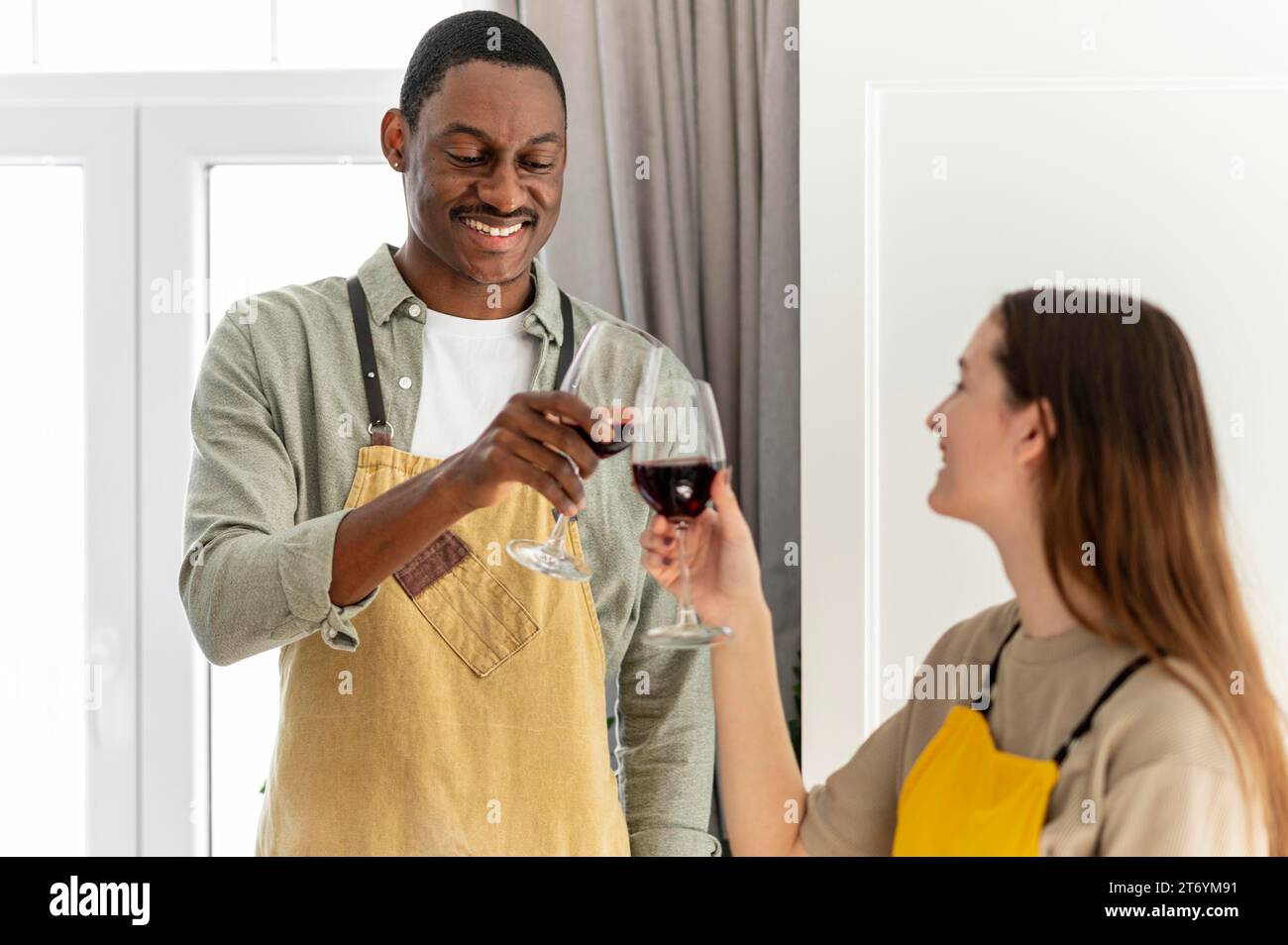 Medium shot friends clinking glasses Stock Photo - Alamy