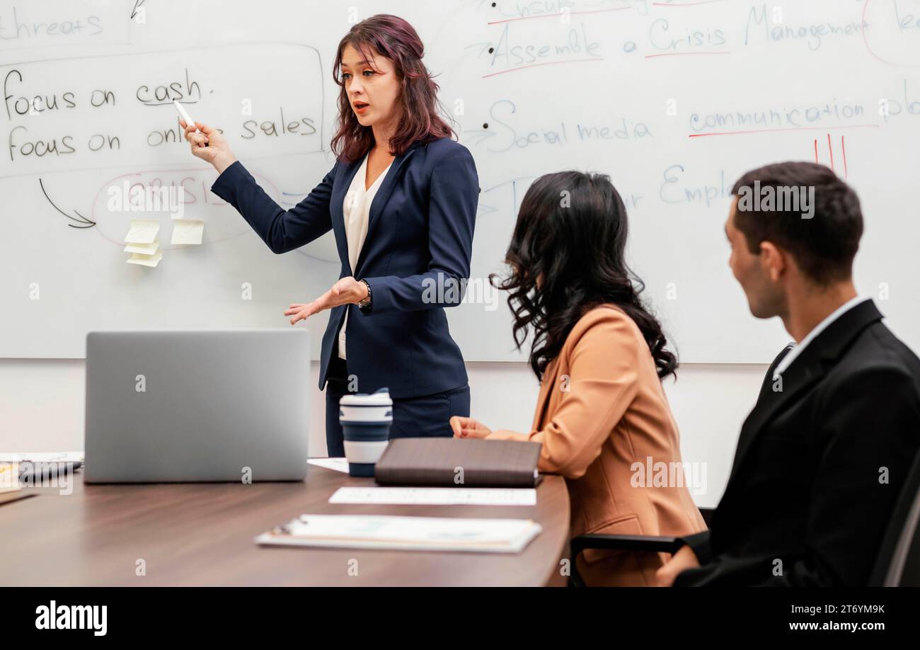 Medium shot team leader explaining board Stock Photo - Alamy