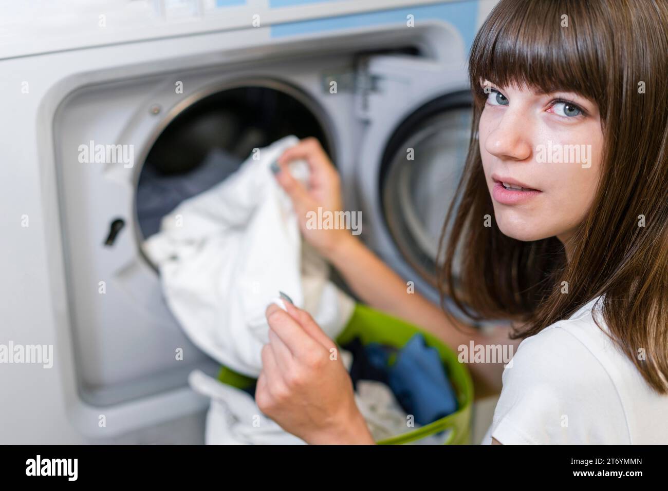 Portrait cute woman doing laundry Stock Photo - Alamy