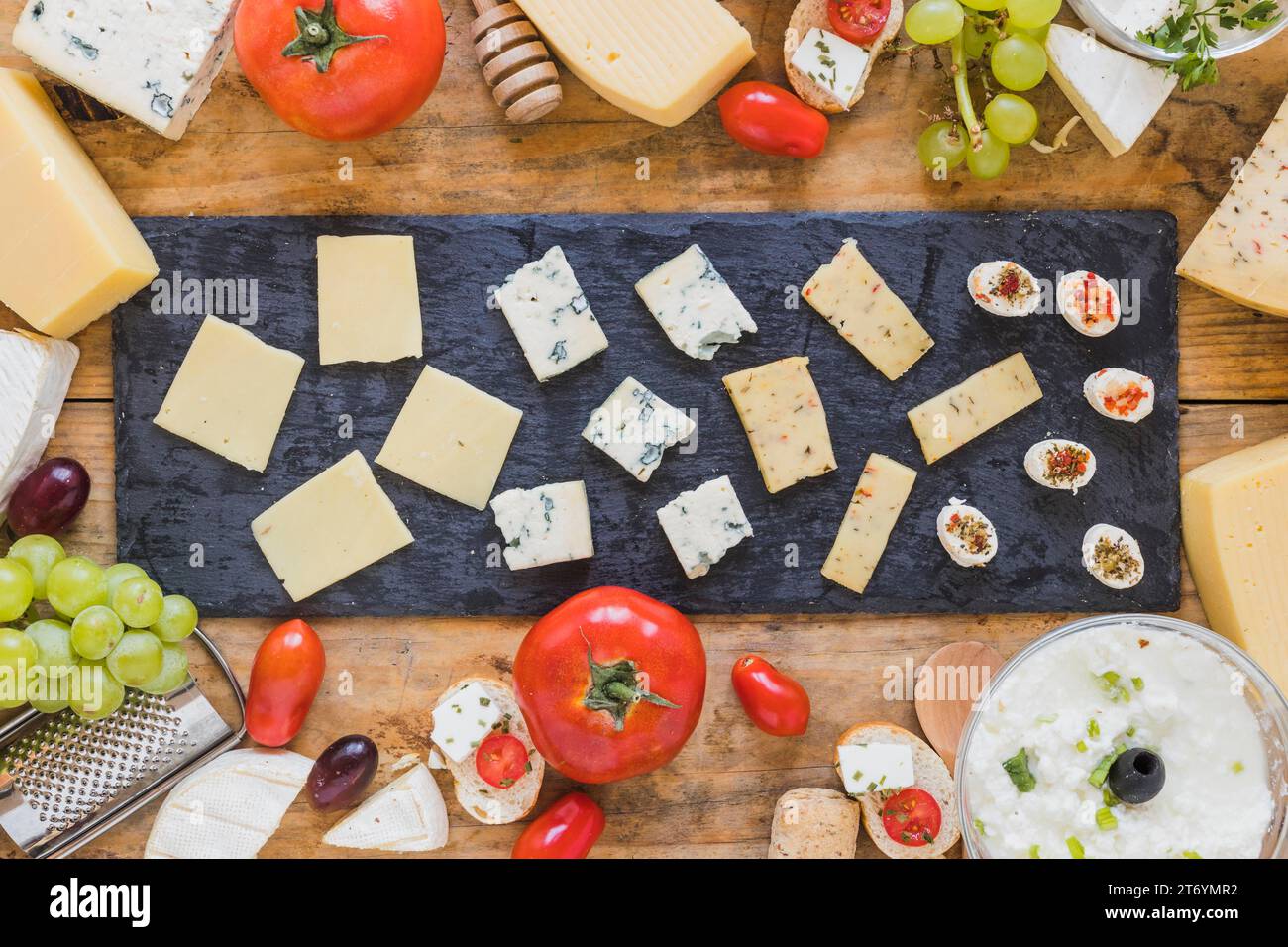Platter cheese slice black slate board table Stock Photo - Alamy