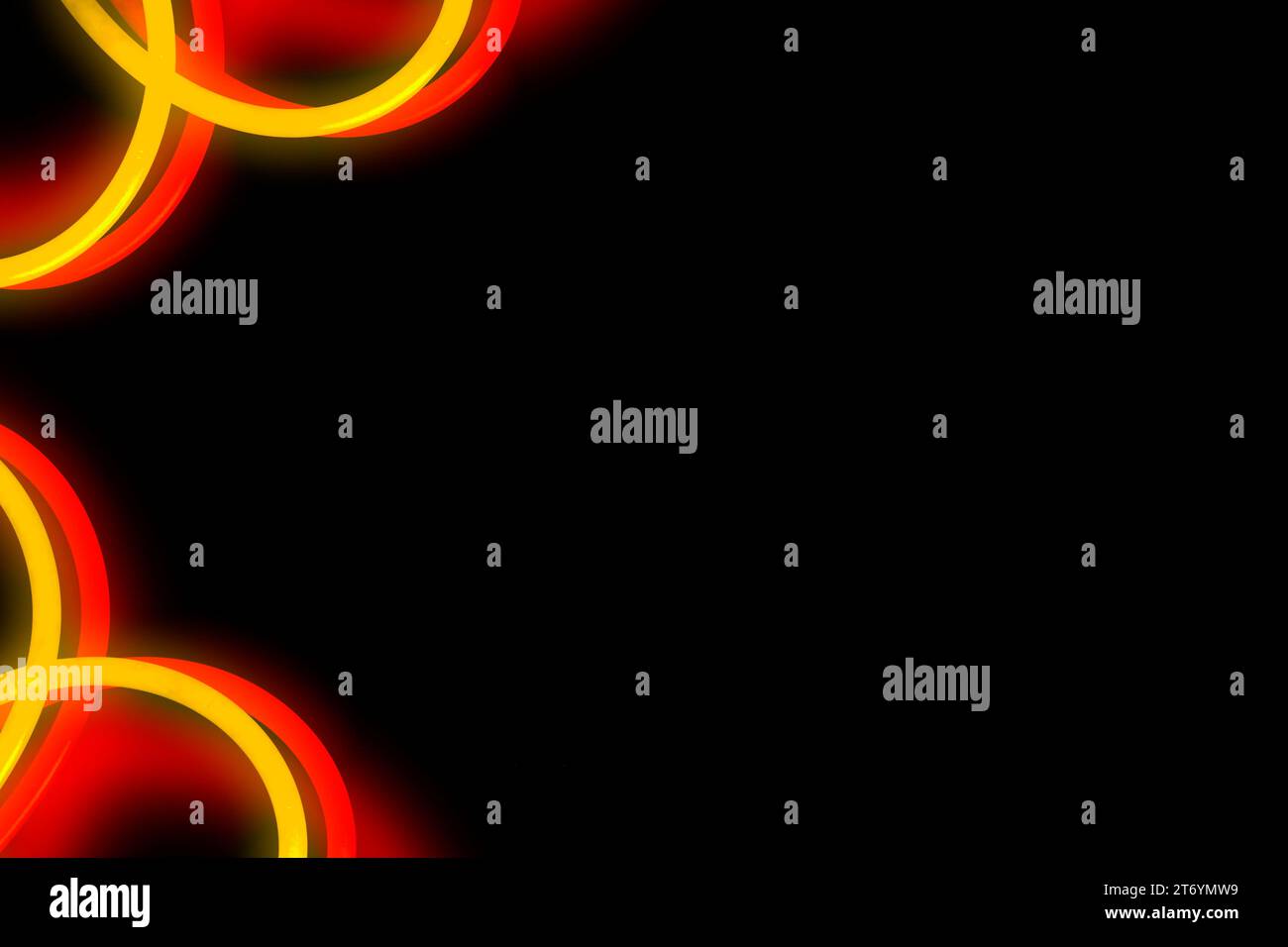 Red yellow neon curved design black background Stock Photo - Alamy