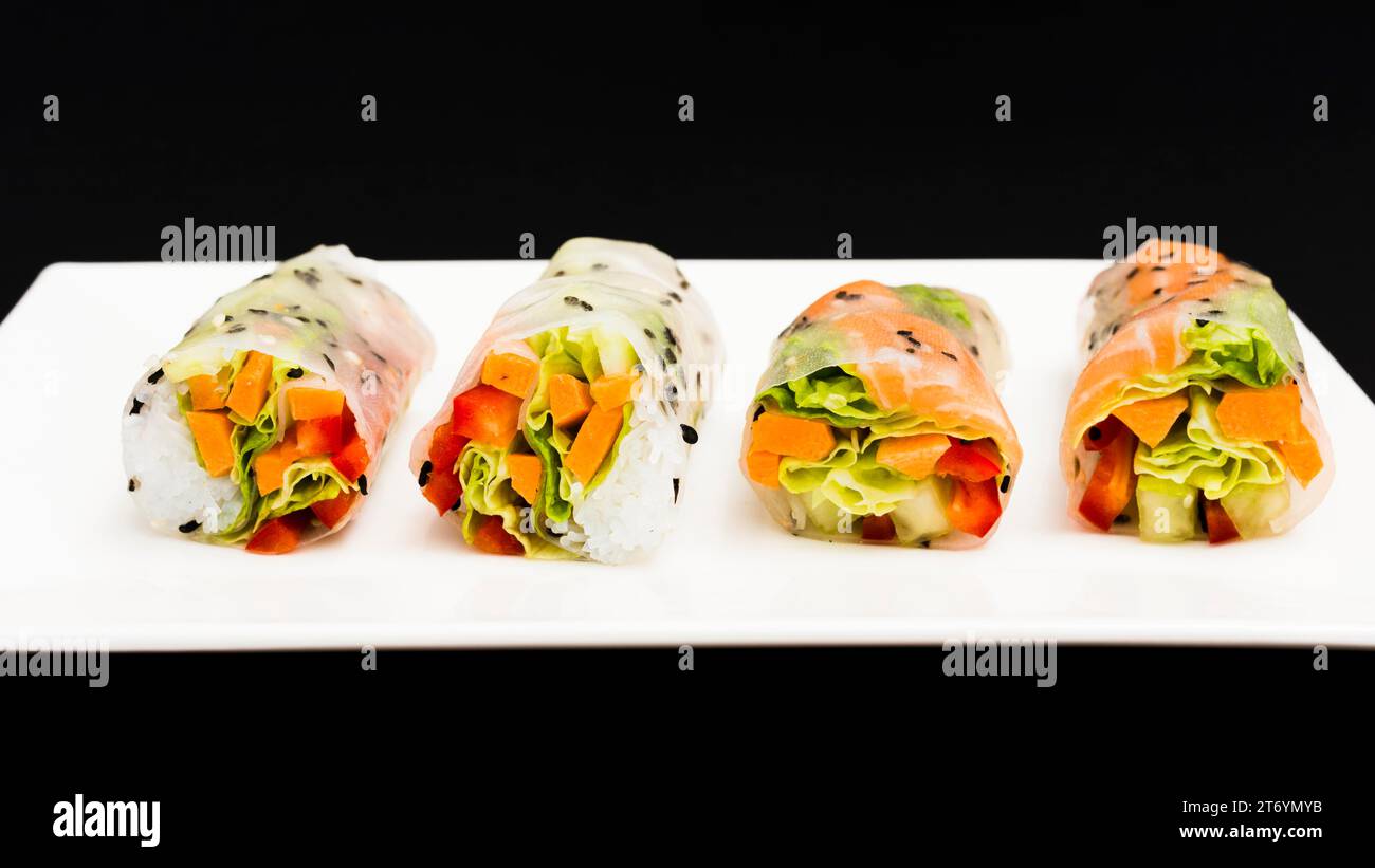 Row healthy spring rolls plate Stock Photo - Alamy
