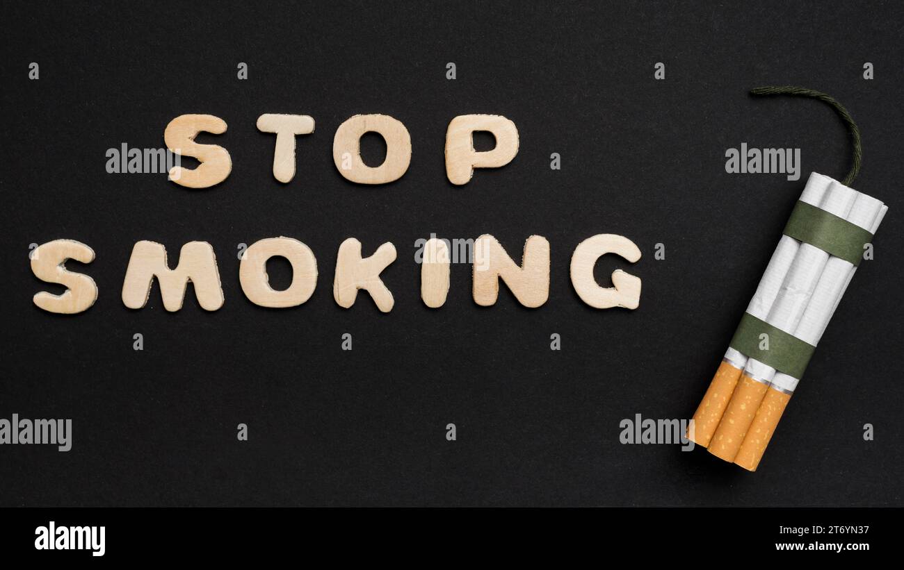Stop smoking text with bunch cigarette arranged black background Stock ...