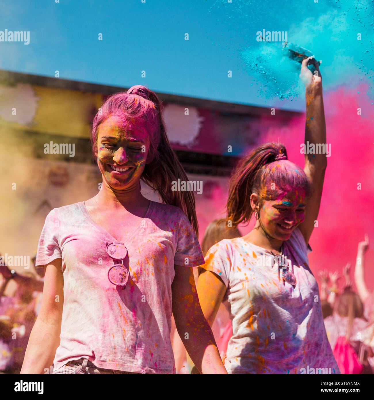 Two young women covered with holi color dancing holi festival Stock ...