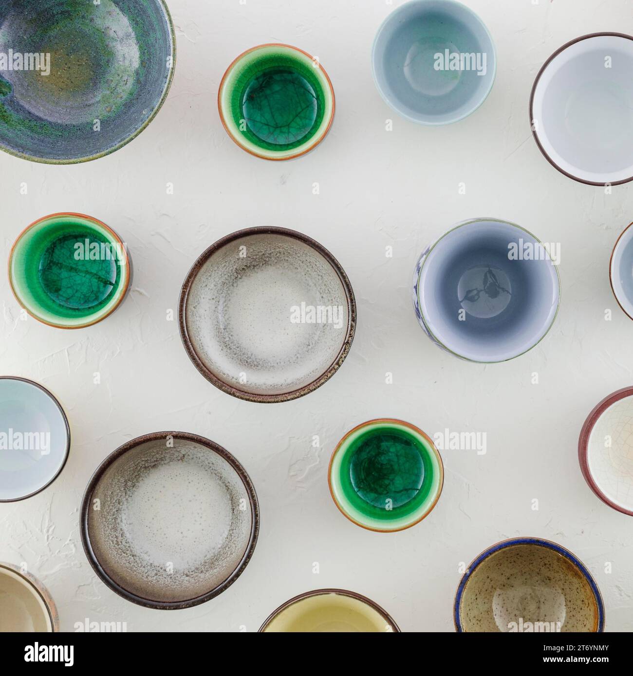 Various type ceramic tea cups isolated white textured background Stock ...