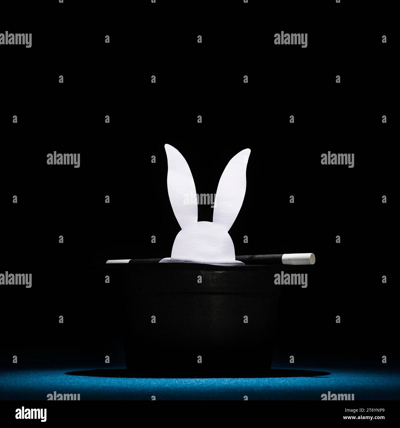 White paper cut out rabbit heads top black hat with magic wand Stock ...