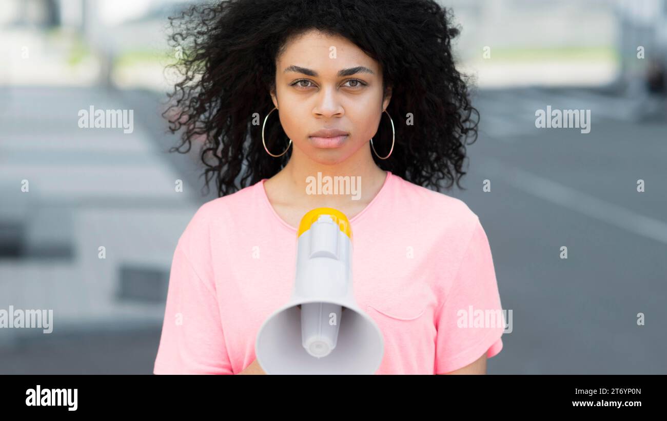 Woman with curly hair protesting front view Stock Photo - Alamy