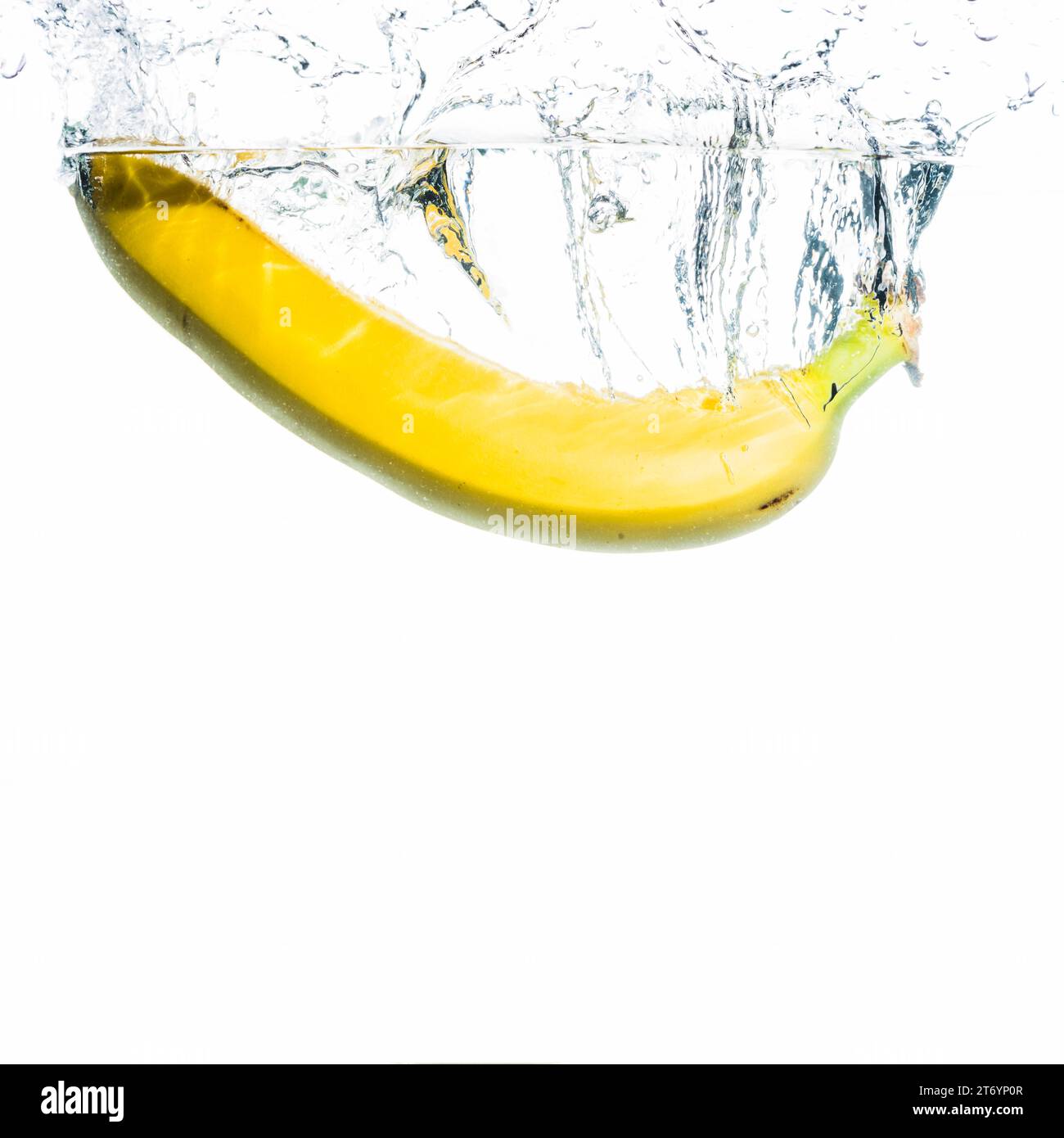Yellow banana splashing into water against white background Stock Photo ...
