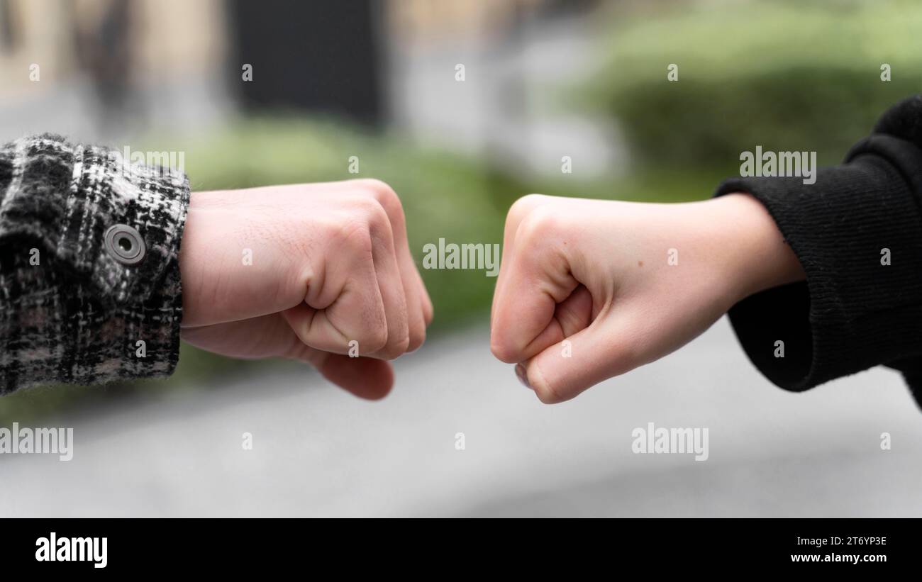 Alternative greetings almost touching fist bumps Stock Photo - Alamy