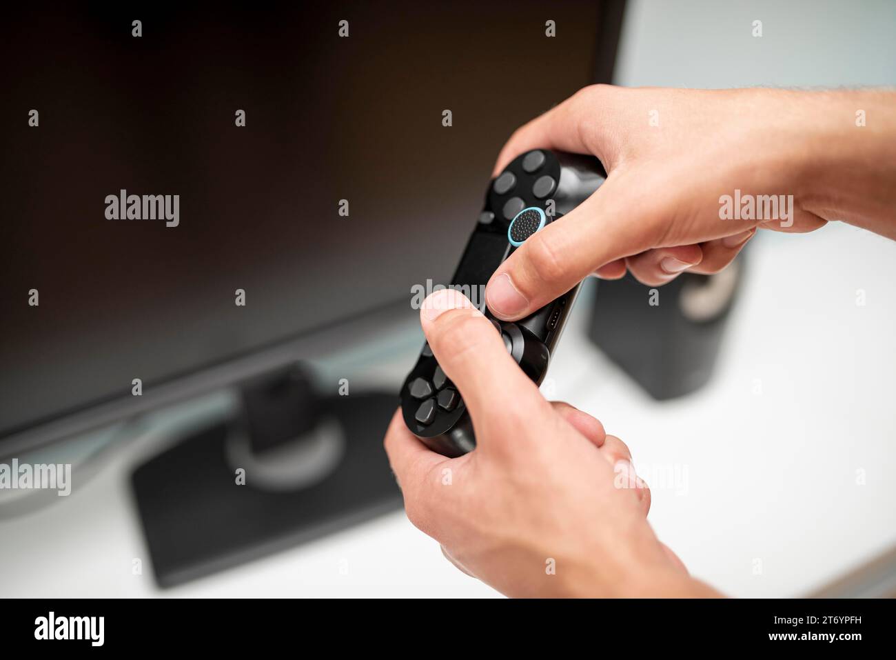 Close up guy holding controller Stock Photo - Alamy