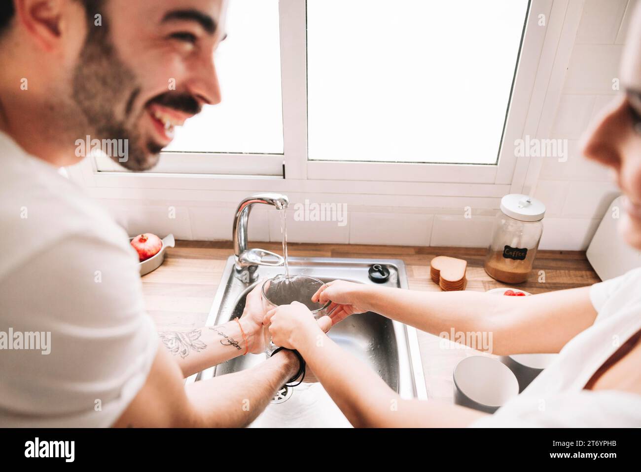 Cheerful couple washing jug Stock Photo - Alamy