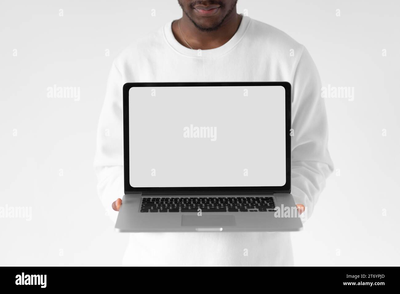 Close up man holding open laptop Stock Photo - Alamy