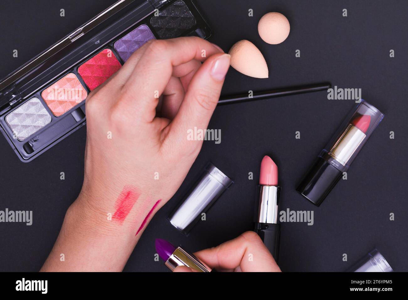 Close up woman trying lipstick shade hand against black backdrop Stock ...