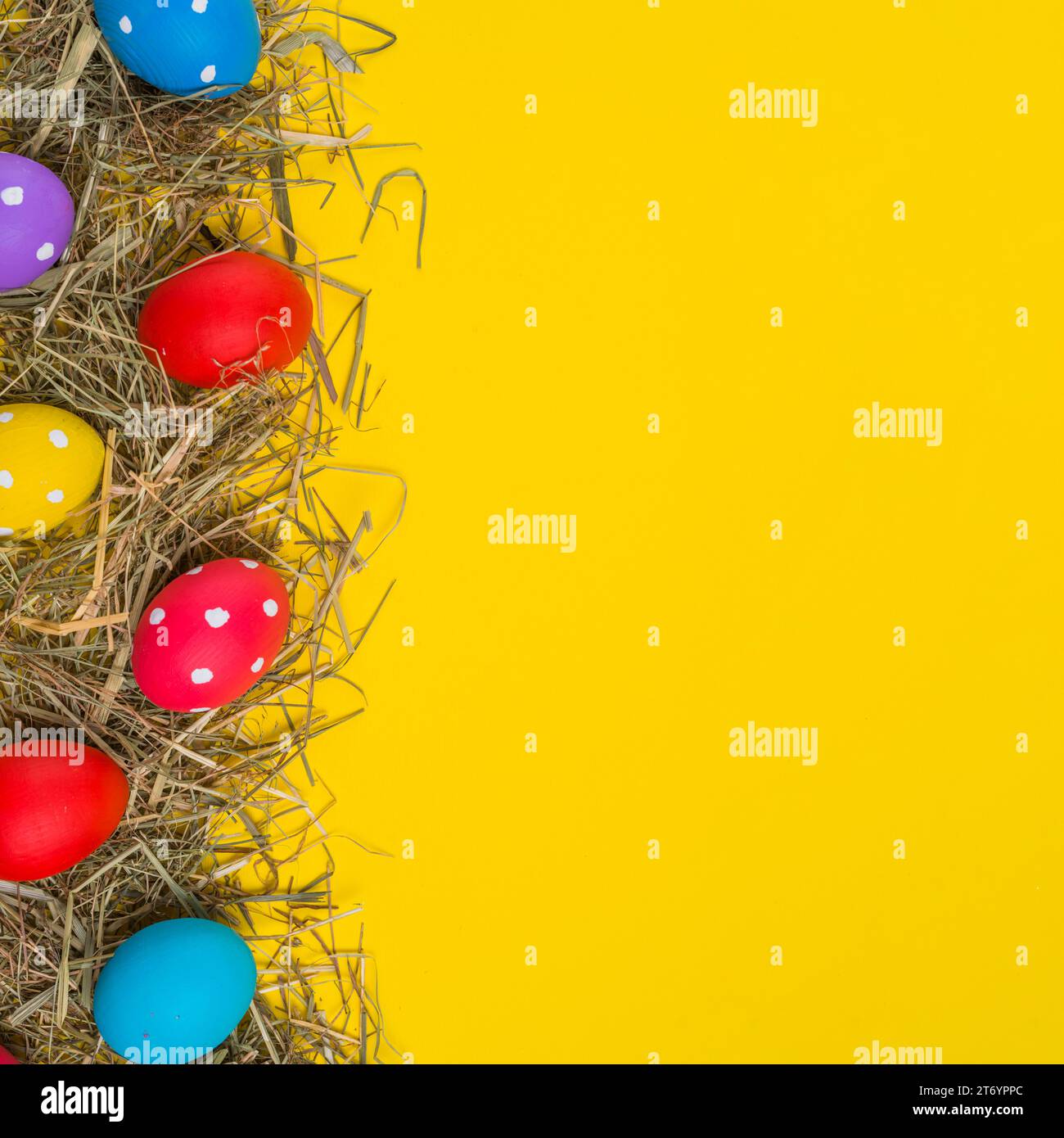 Colorful easter eggs scattered hay Stock Photo - Alamy
