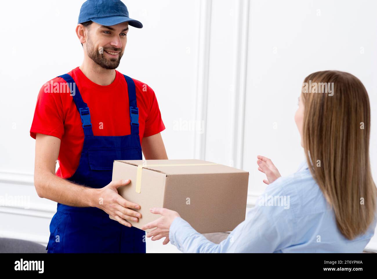 Woman courier delivering carton hi-res stock photography and images - Alamy