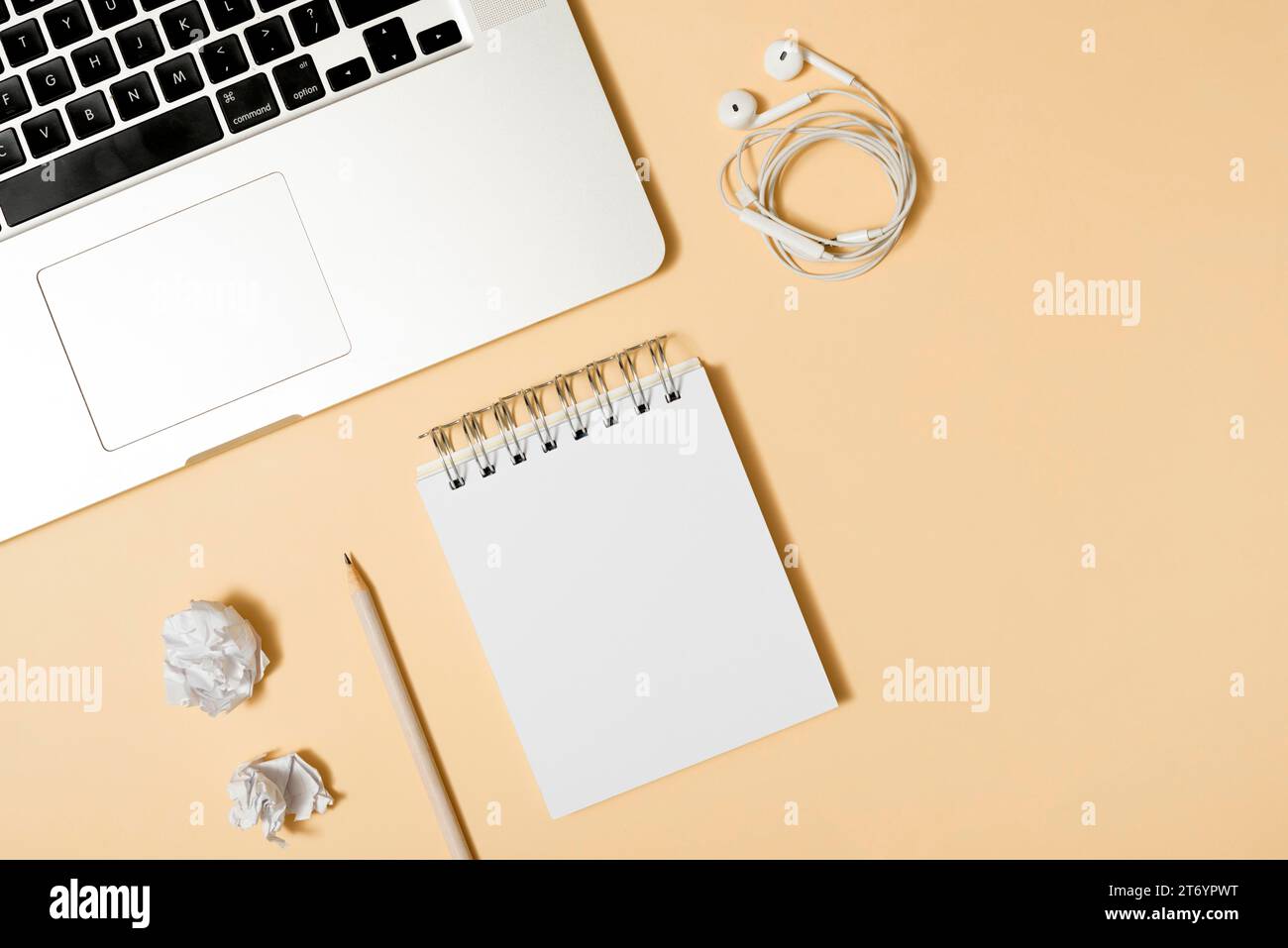 Crumpled paper notepad pencil earphone laptop beige background Stock ...