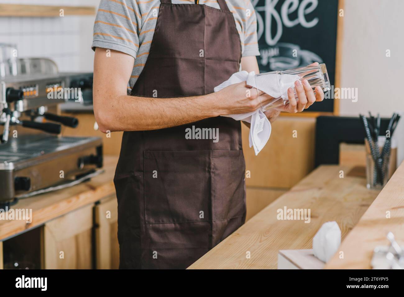 Crop bartender drying glasses Stock Photo - Alamy