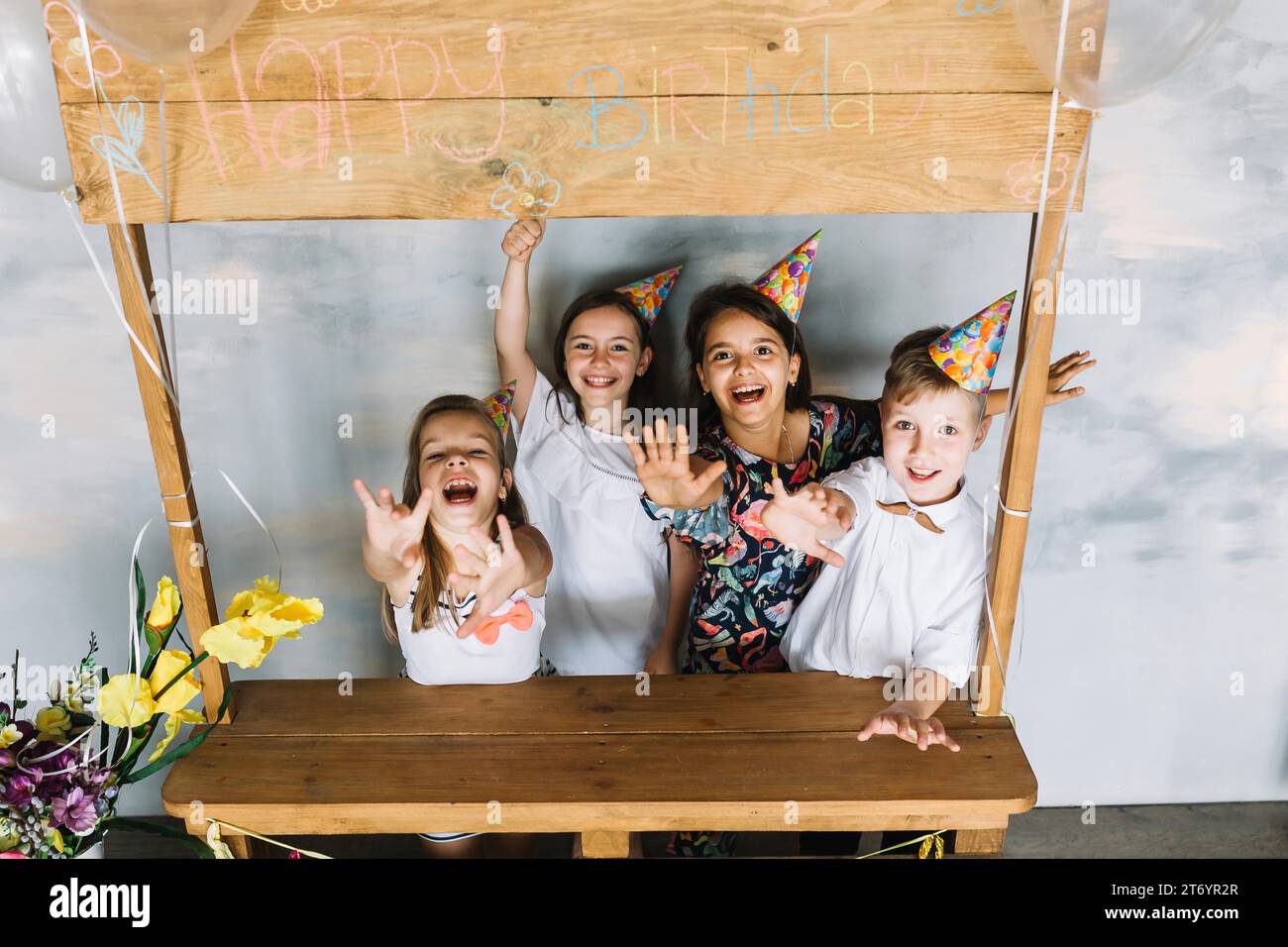 Excited kids stretching out arms birthday party Stock Photo - Alamy