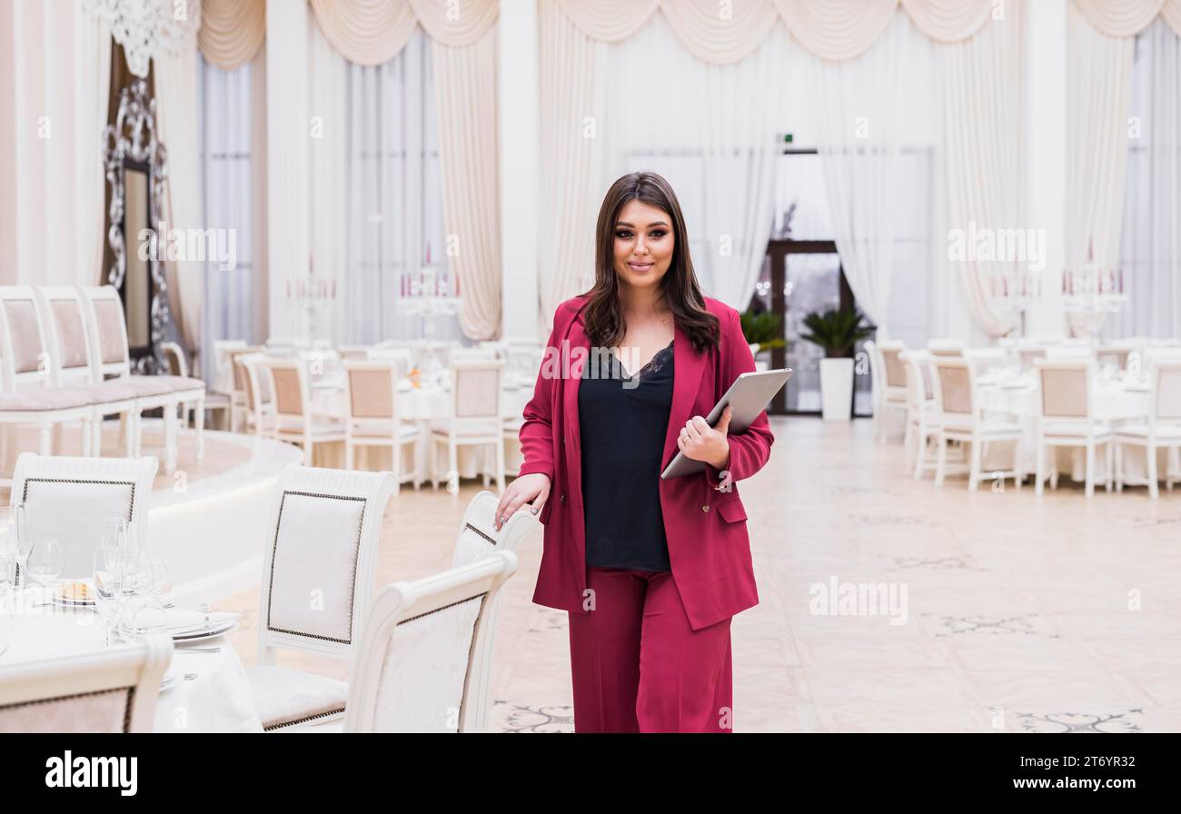 Event manager with laptop banquet hall Stock Photo - Alamy