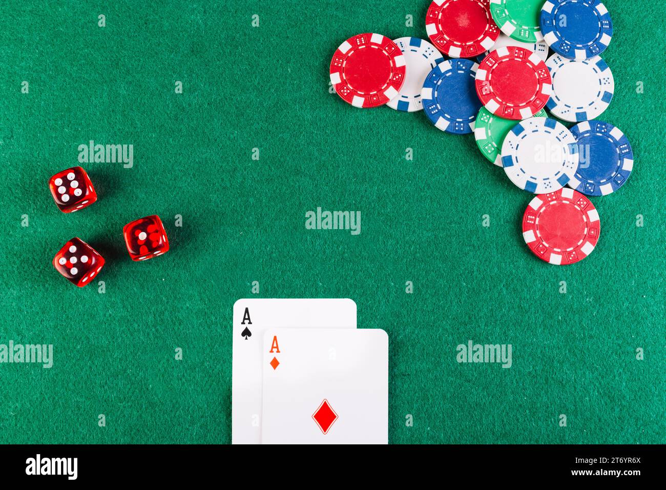 Elevated view ace playing cards dice chips poker table Stock Photo - Alamy