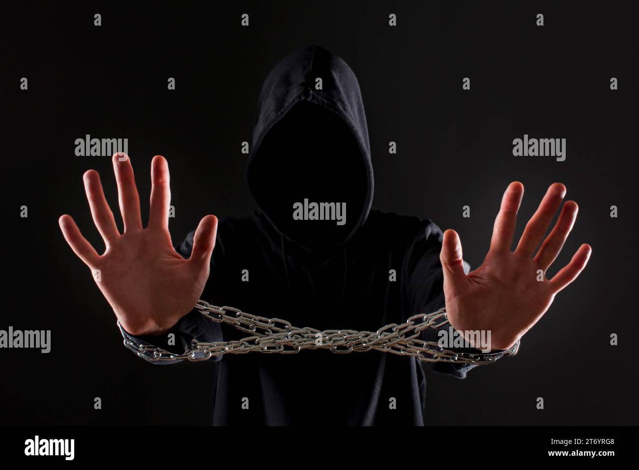 Front view male hacker with metal chain around hands Stock Photo - Alamy