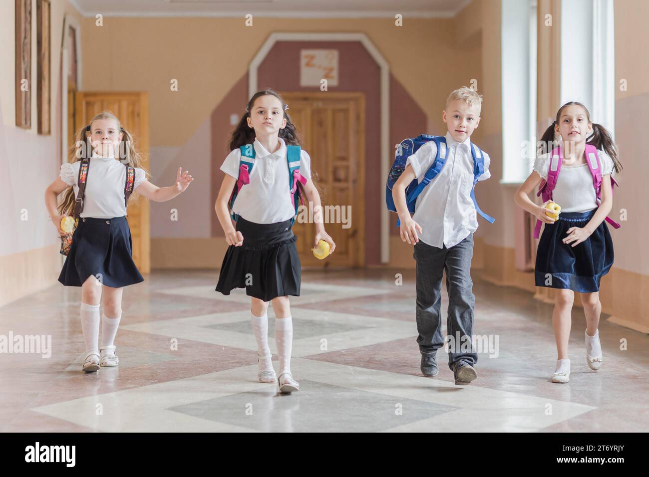 Funny kids with apples school corridor Stock Photo - Alamy