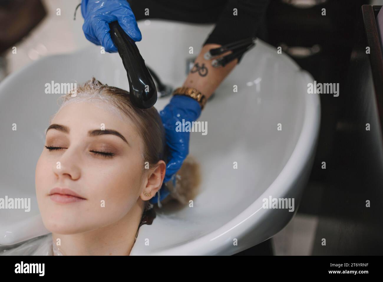 Hairdresser washing hair handsome client hi-res stock photography and images - Alamy