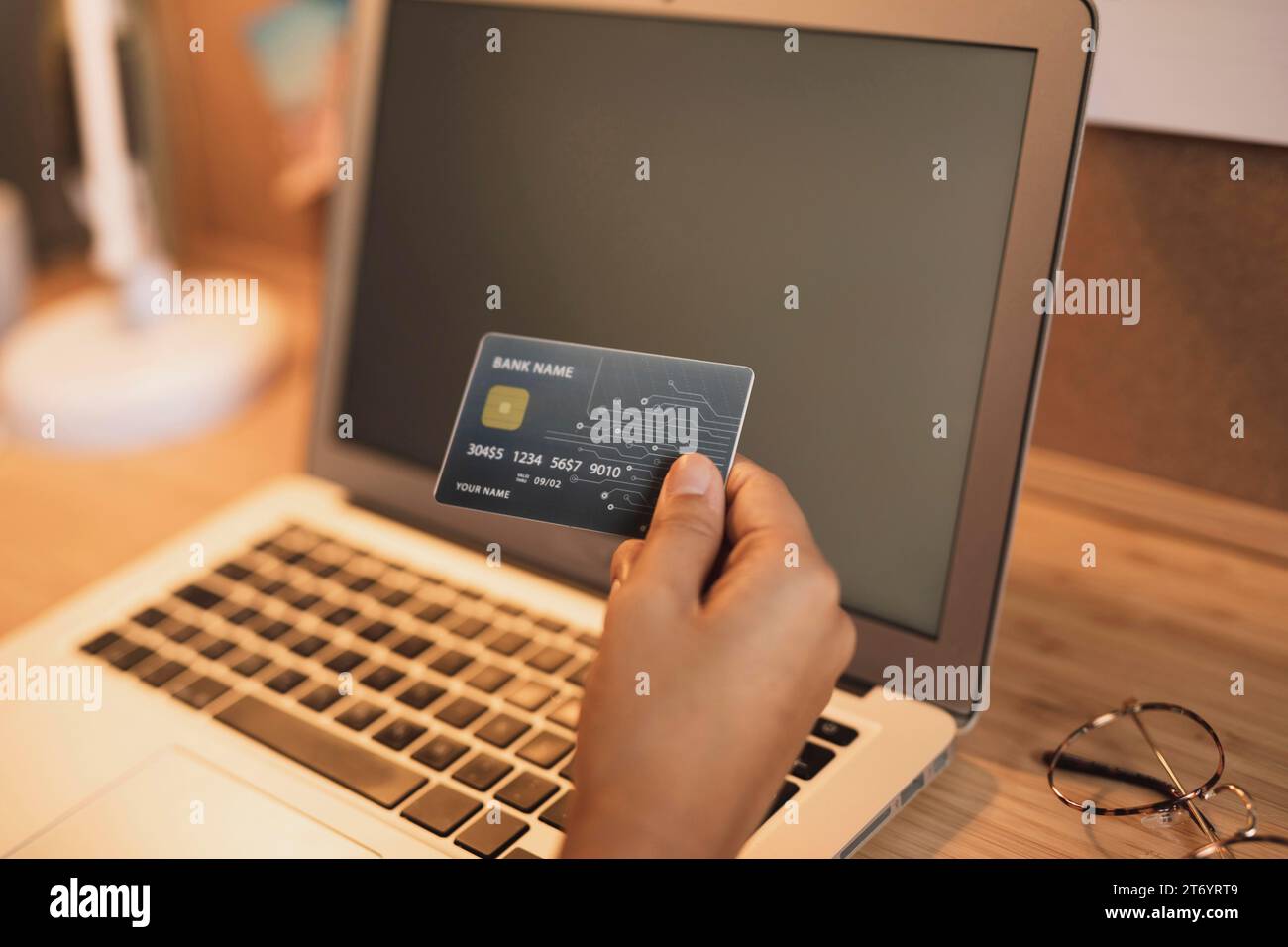 Hand showing credit card laptop mock up Stock Photo - Alamy