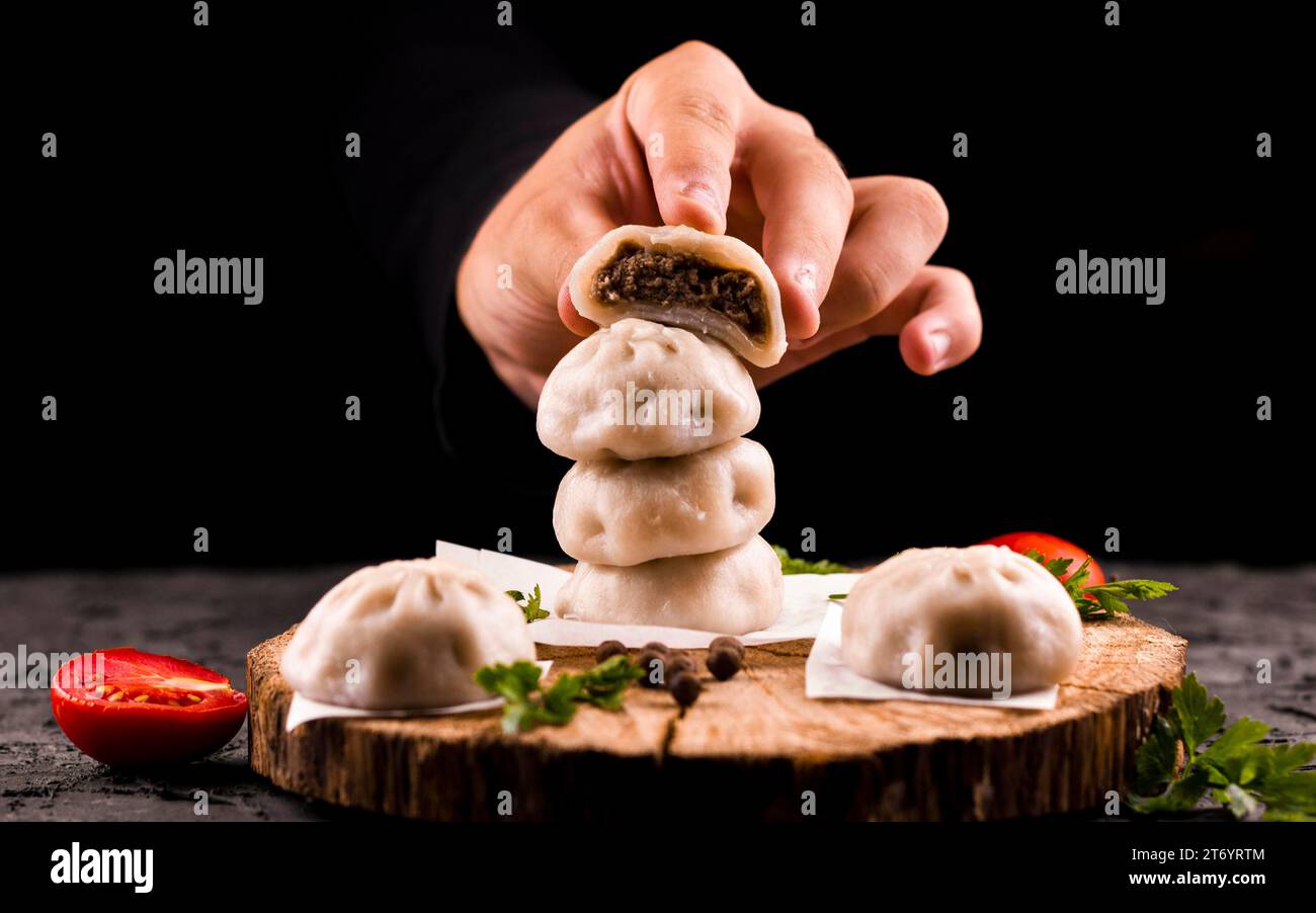 Hand holding meat dumpling Stock Photo - Alamy