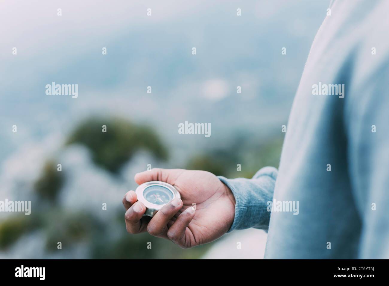 Hiker looking compass Stock Photo - Alamy