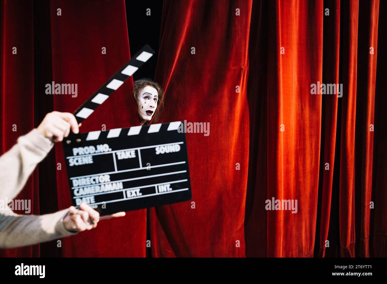 Human hand holding clapperboard front male mime artist face Stock Photo ...