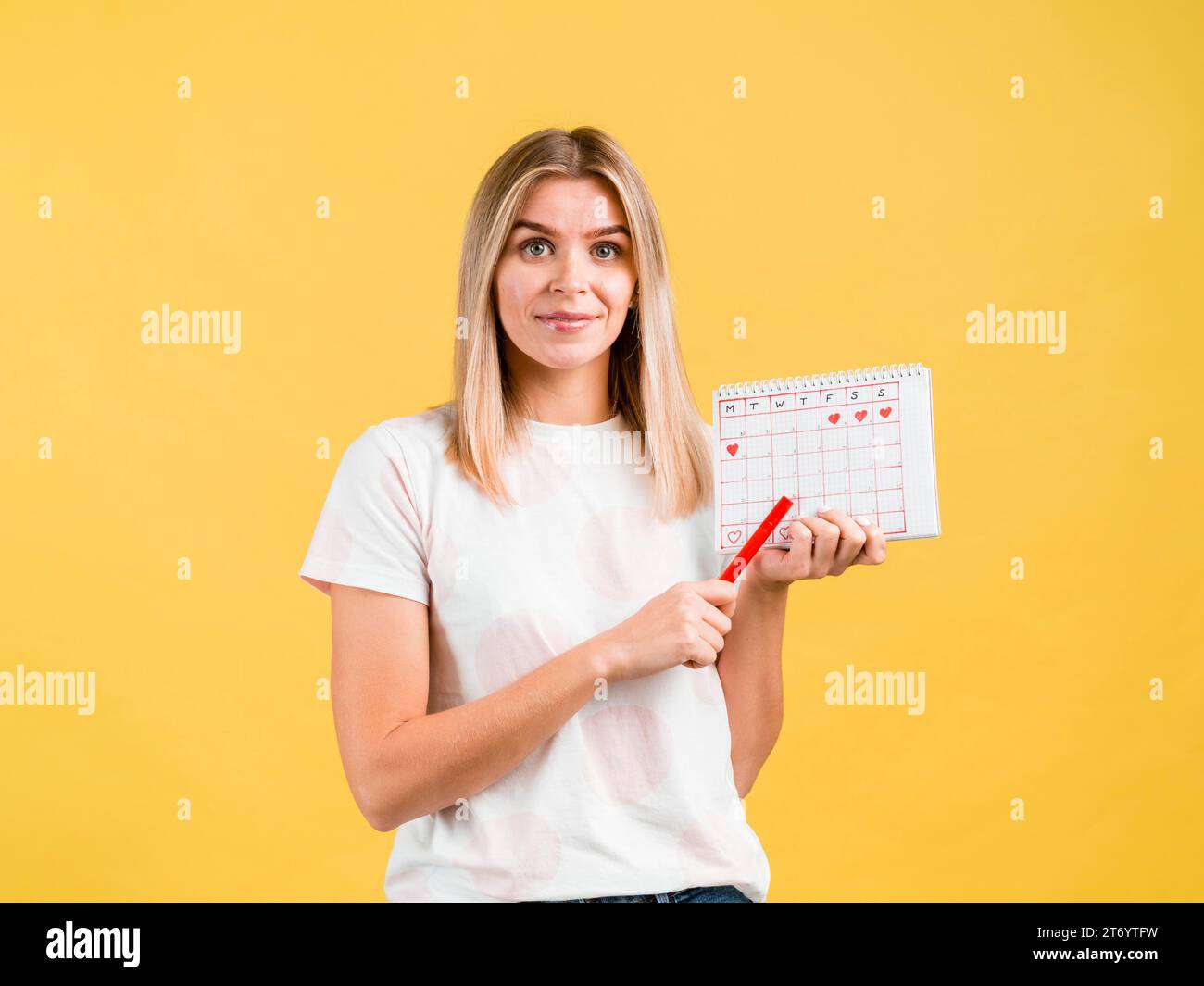 Medium shot woman holding pen period calendar Stock Photo - Alamy