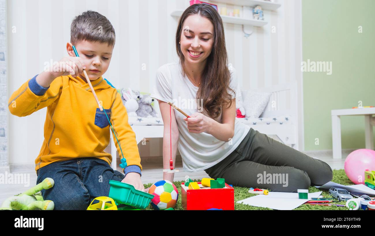 Mother son playing game Stock Photo - Alamy