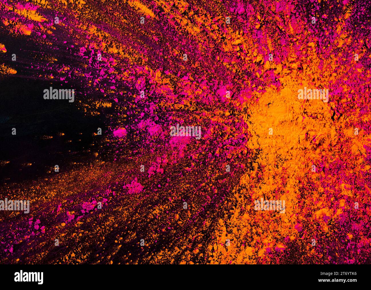 Mixed orange pink powder holi colors against black backdrop Stock Photo ...
