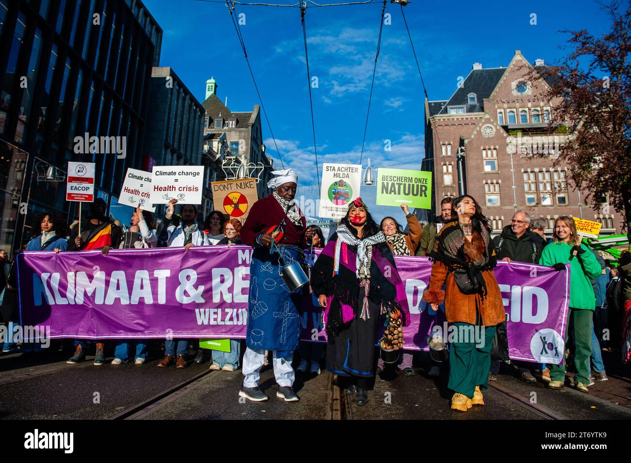 Protesters are seen holding a banner and placards during the ...