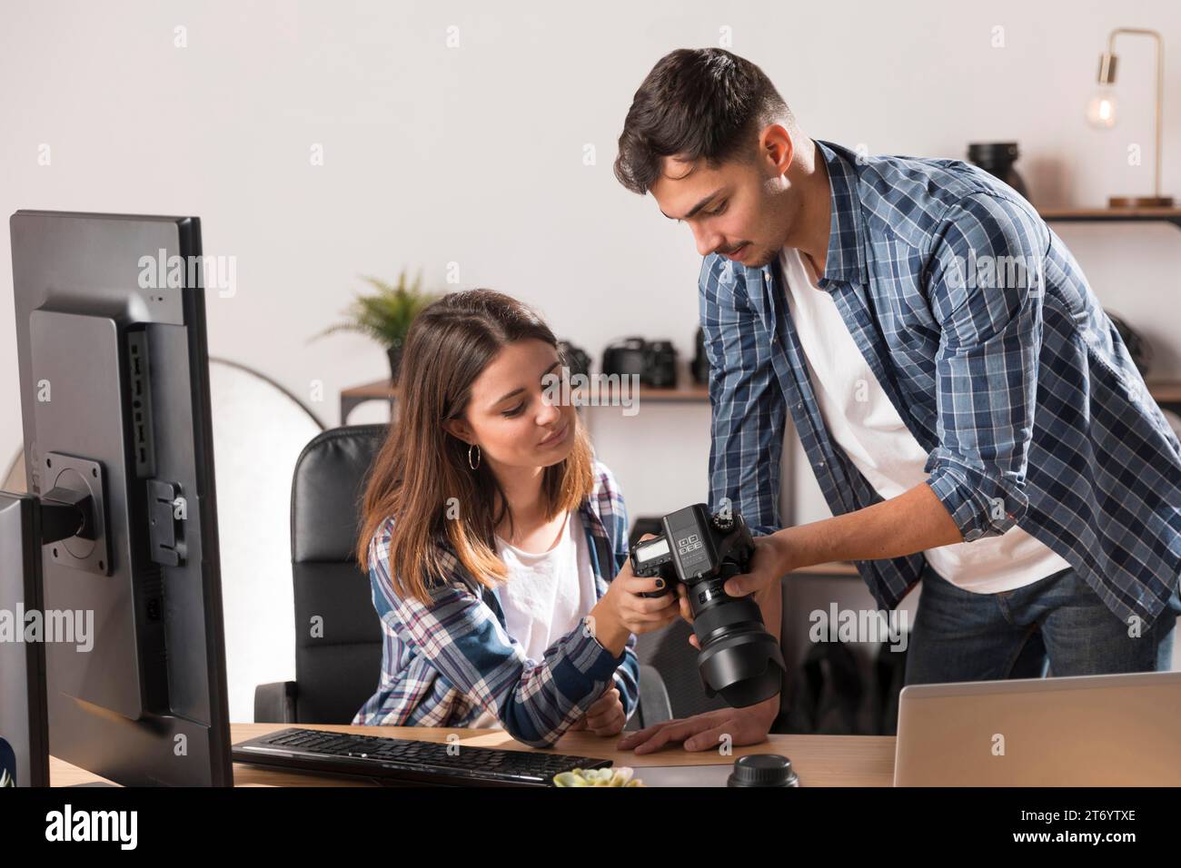 People looking together s camera Stock Photo - Alamy