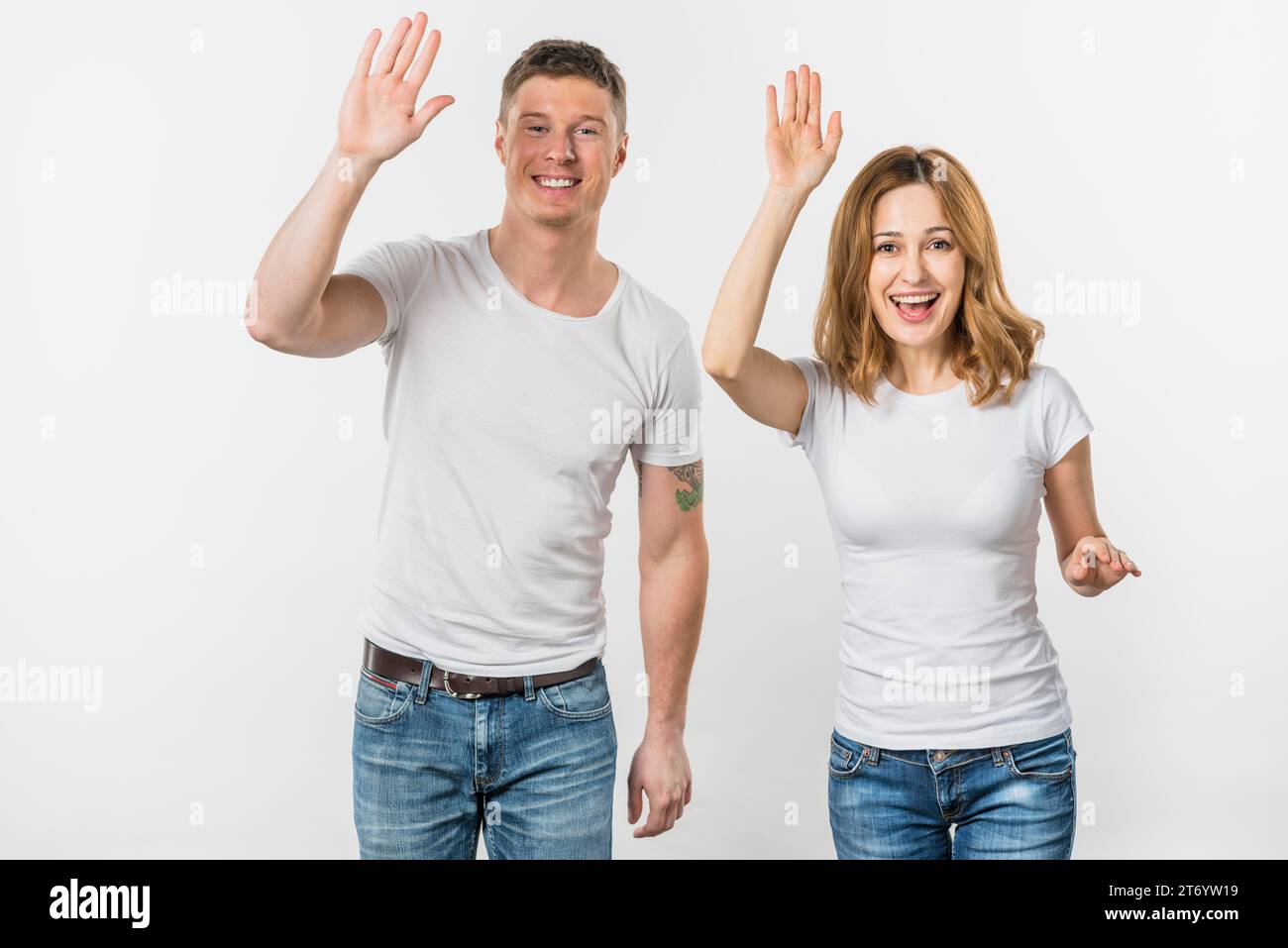 Portrait smiling young couple waving their hands looking camera Stock ...
