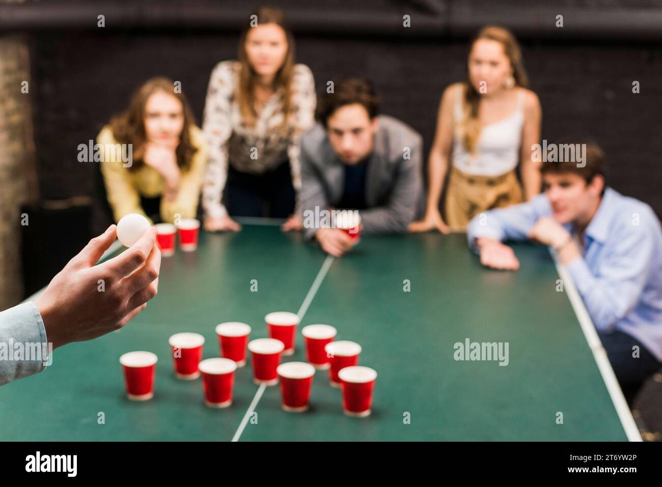 Person s hand aiming ball beer pong game Stock Photo - Alamy