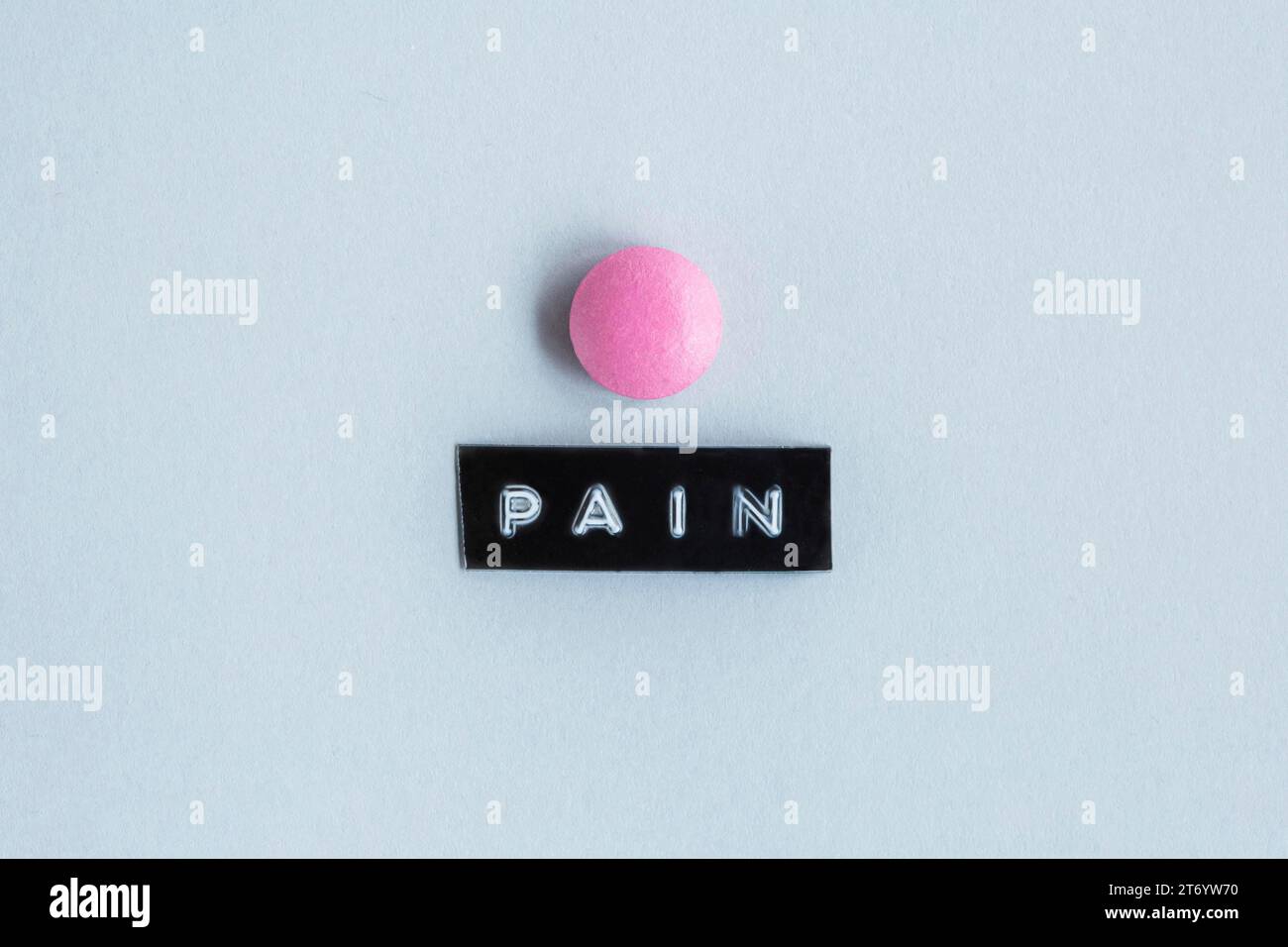 Pink color table with pain label Stock Photo - Alamy