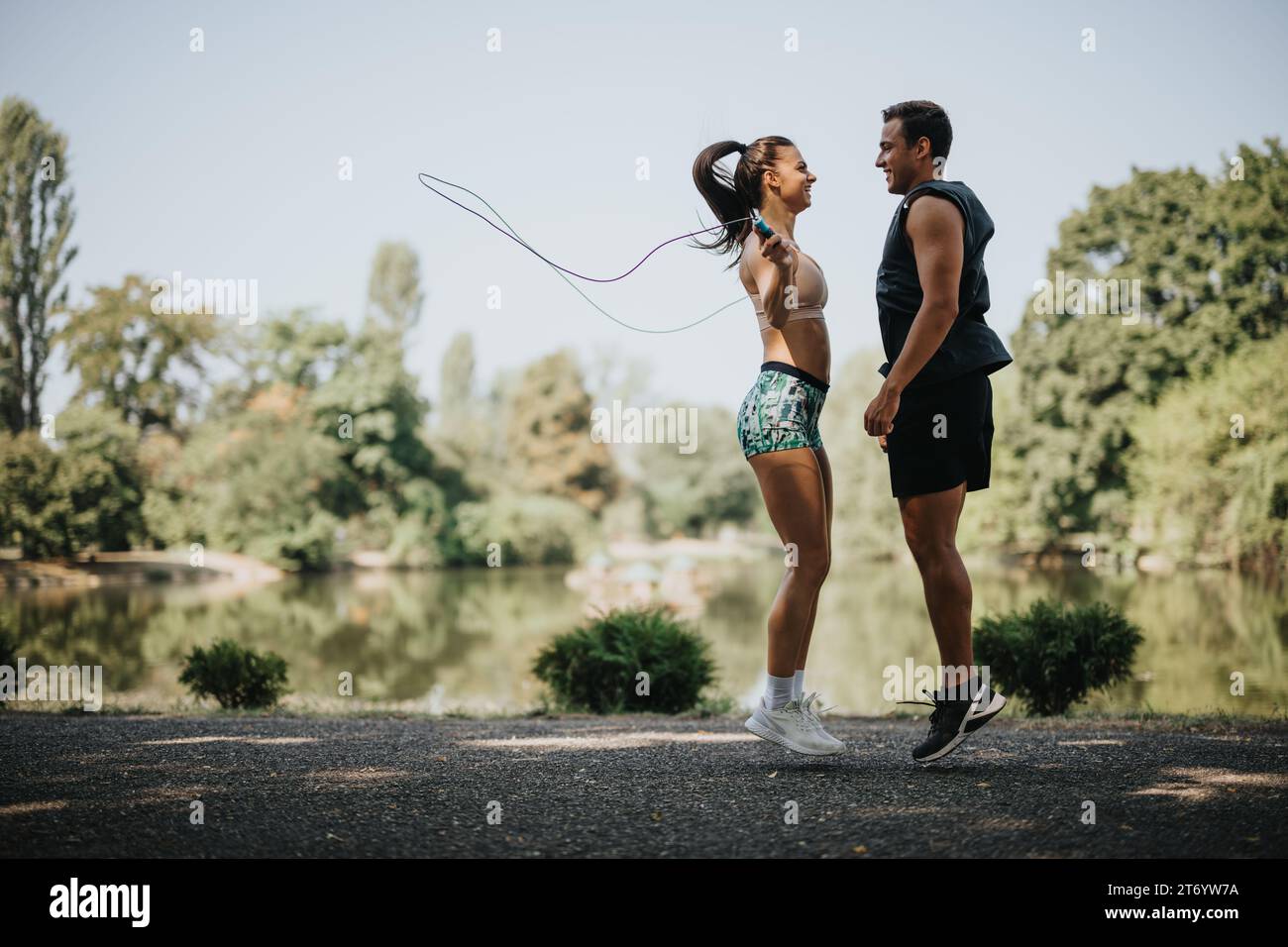 Active Couple Motivating Each Other with Outdoor Jumping Rope Workout ...