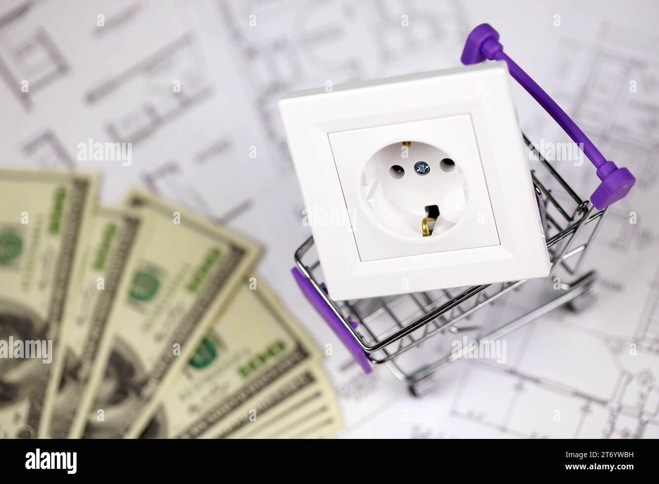 European standard EU outlet in small shopping cart on blueprints of ...