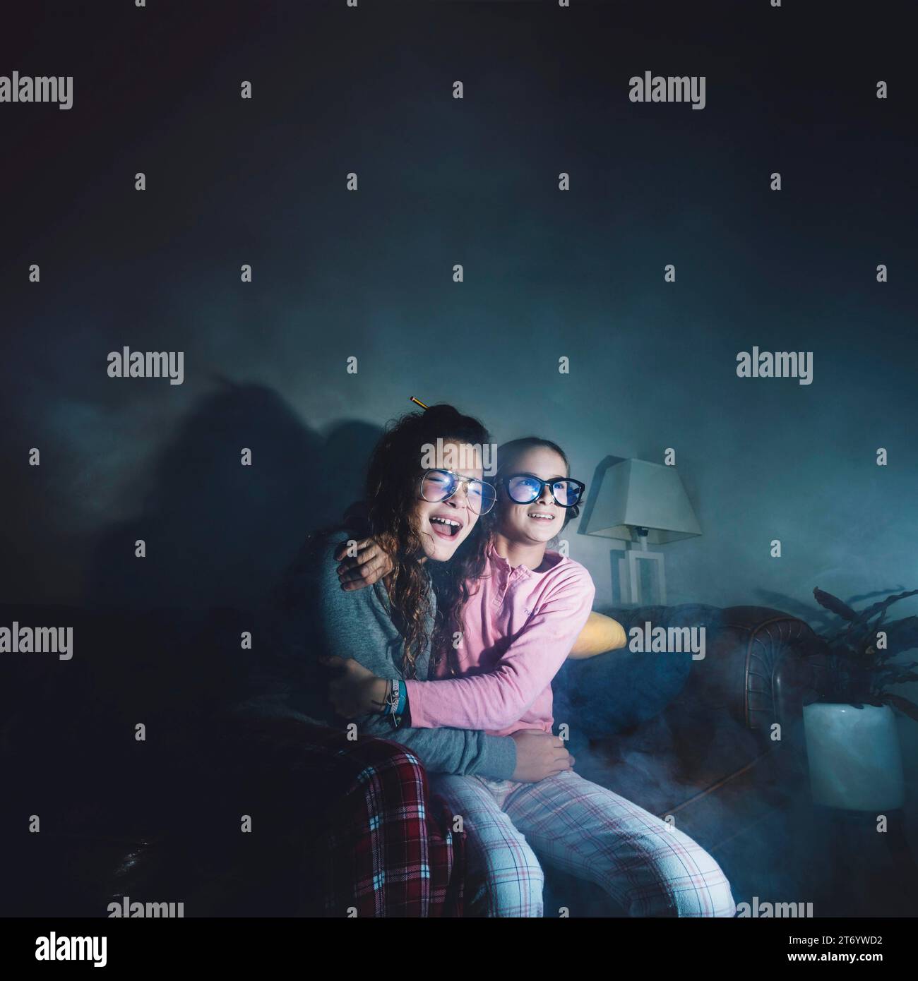 Scared screaming girls watching tv Stock Photo - Alamy
