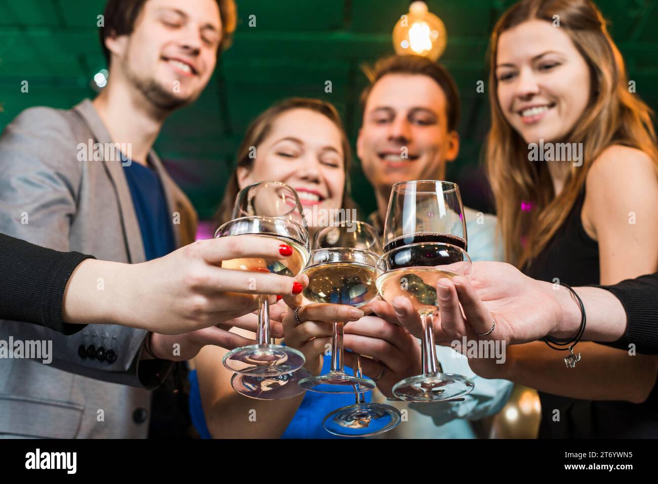 Smiling male female friends toasting cocktails party bar Stock Photo ...