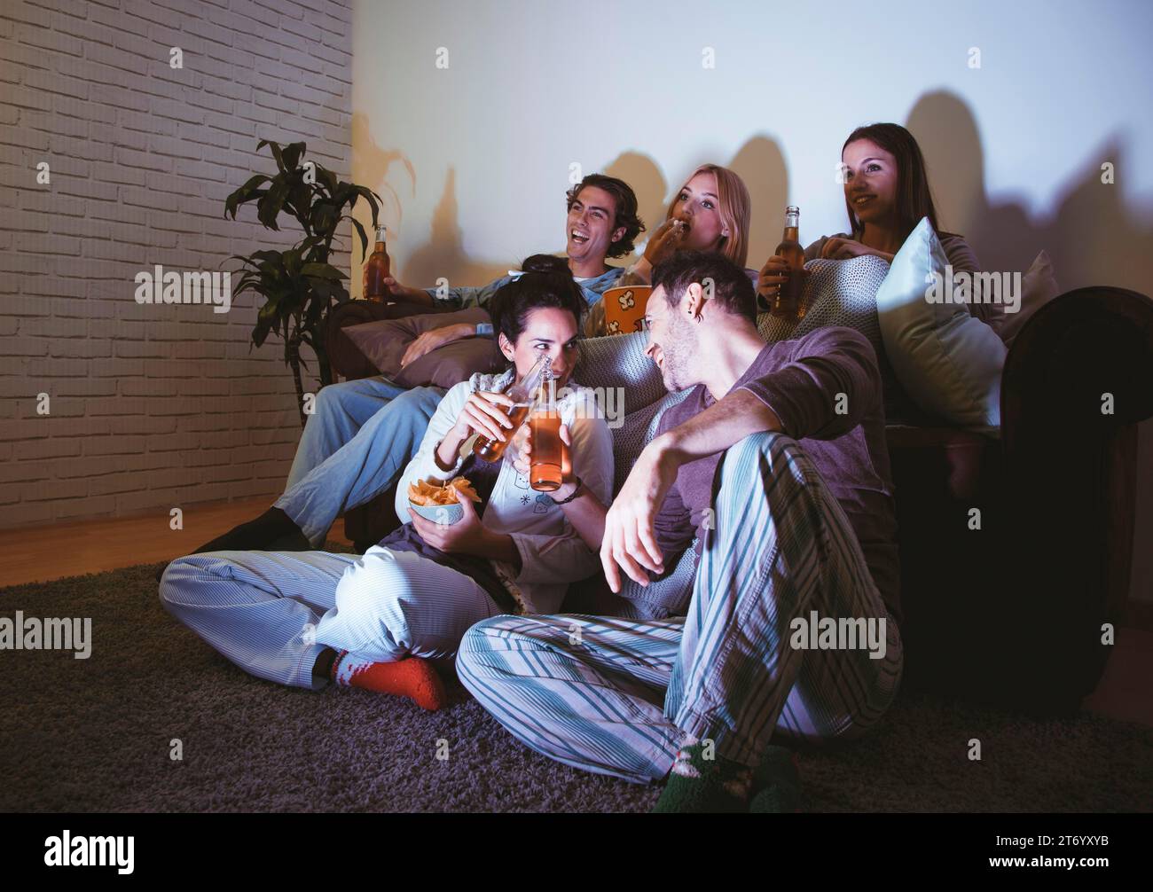 Young friends having movie night Stock Photo - Alamy