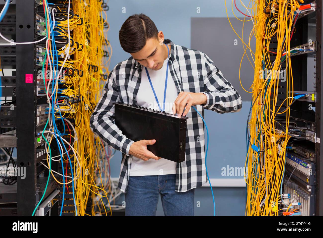 Young network engineer holding ethernet switches Stock Photo - Alamy